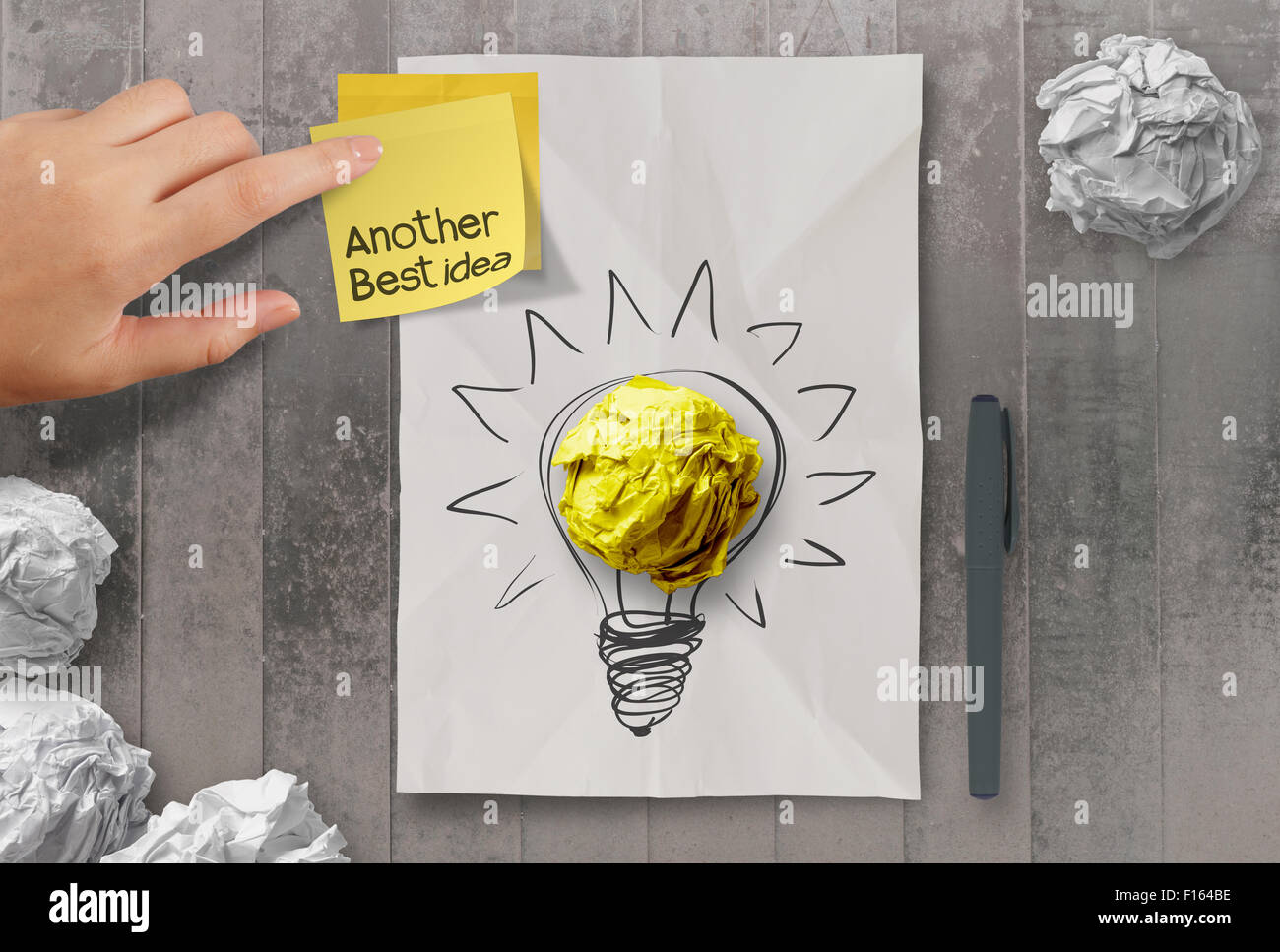 sticky note with another idea light bulb on crumpled paper as creative ...