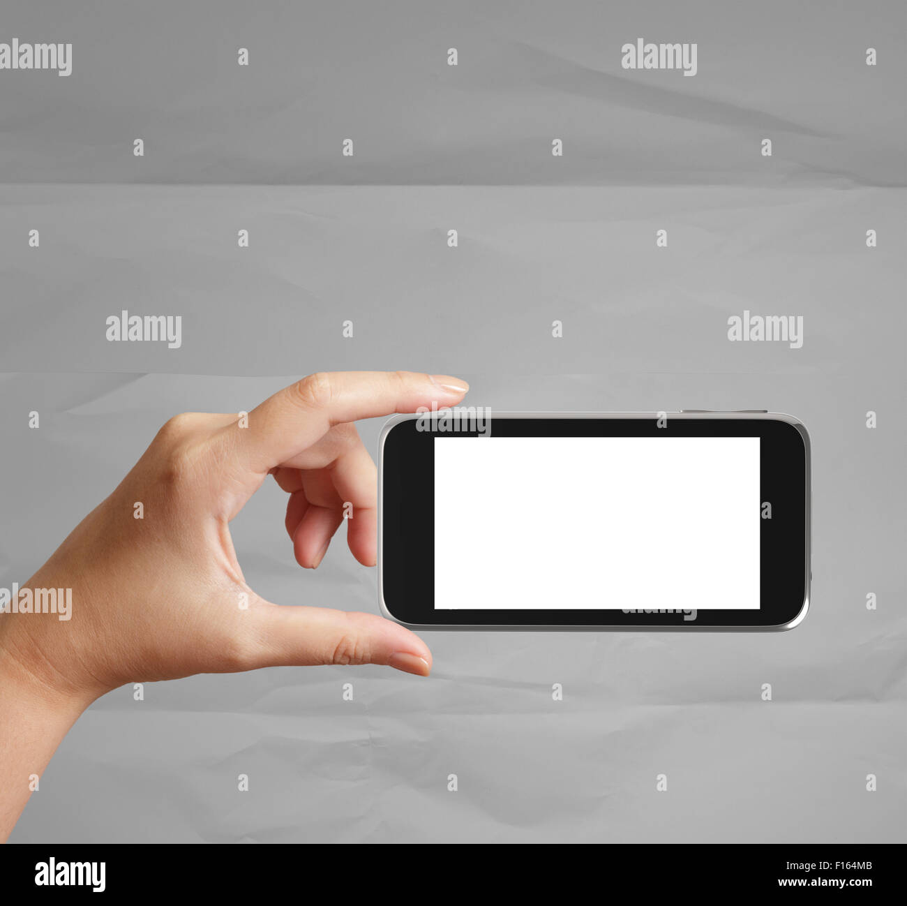 woman hand holding the phone tablet touch computer gadget on crumpled ...