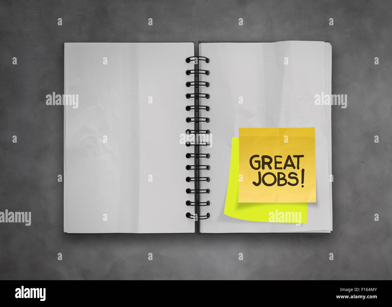 great job word sticky notes with open blank note book on deak top ...