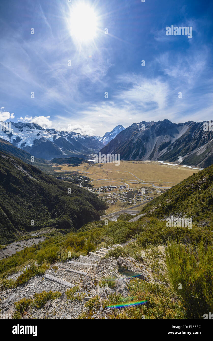 Elevated view of Mount Cook Village with blue sky and mountain range ...