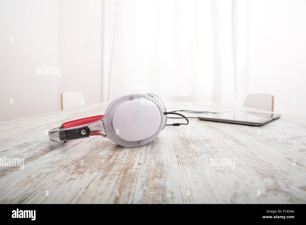 A Tablet PC with headphones on the Table Stock Photo - Alamy