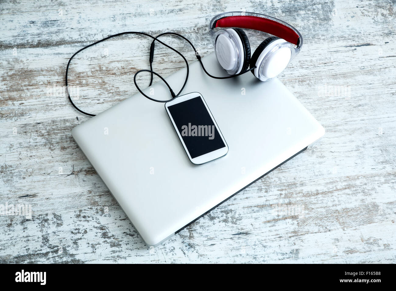 Headphones connected to a smartphone and a Laptop computer Stock Photo ...