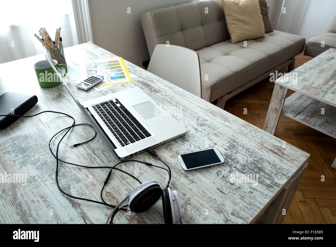 A modern home office setup on a wooden Table Stock Photo - Alamy