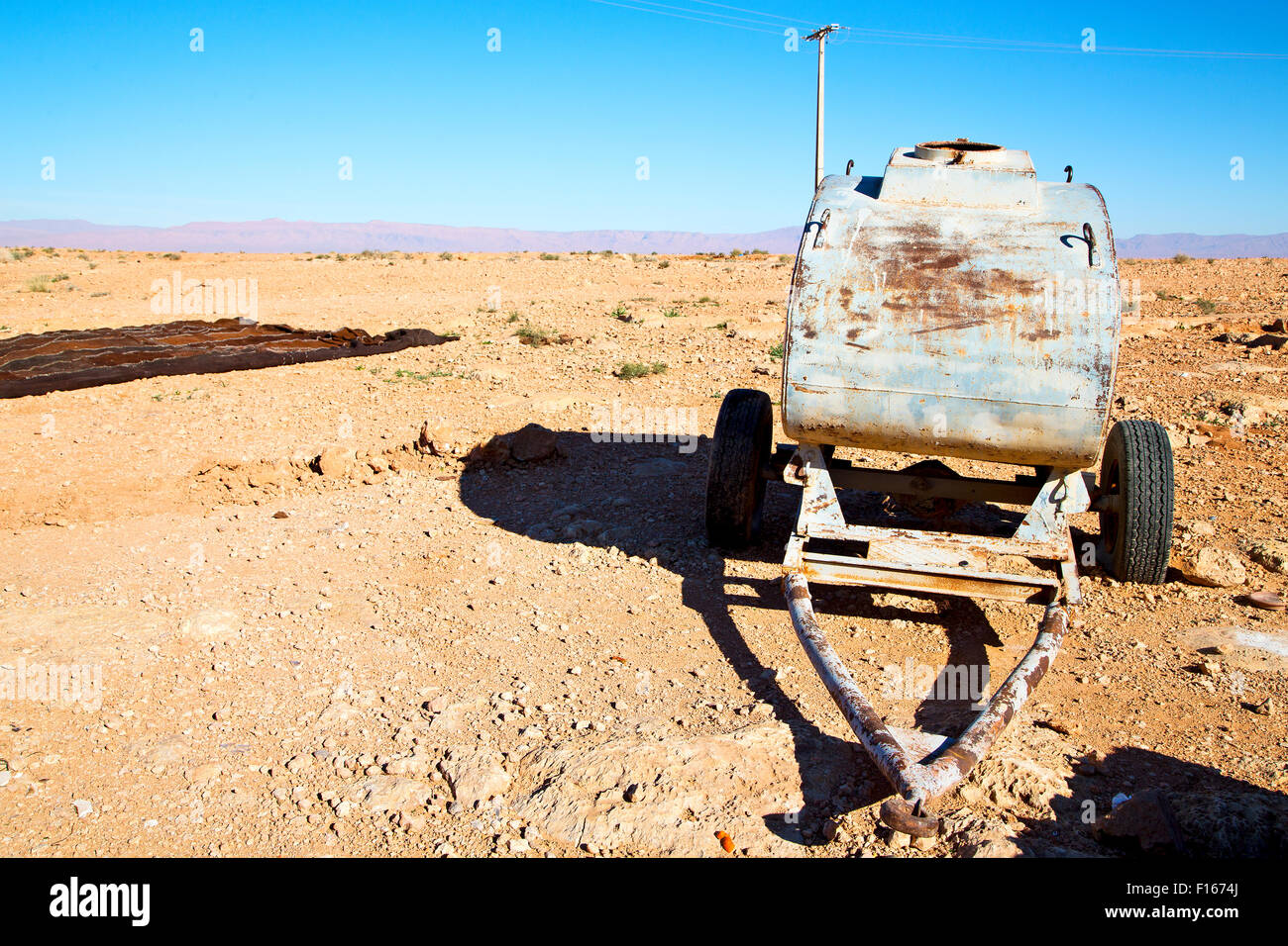 water tank in morocco africa land gray metal weel and arid Stock Photo ...