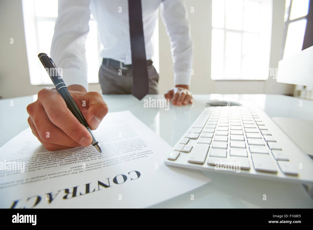Businessman reading contract with attention Stock Photo - Alamy