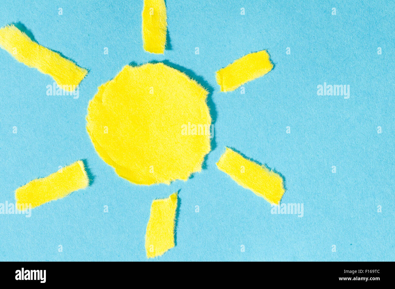 paper sun shape on blue background Stock Photo - Alamy