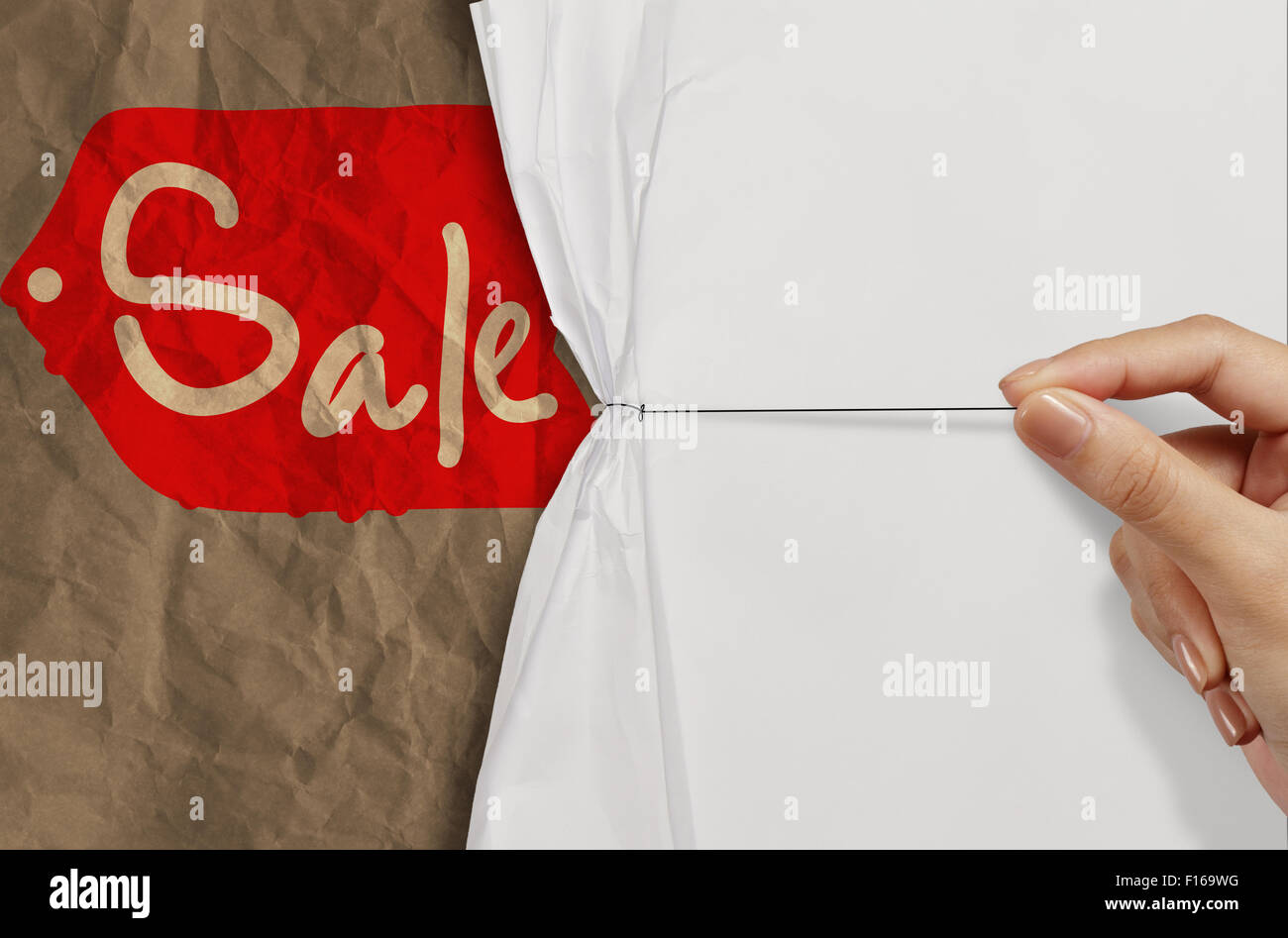 business hand pull rope open wrinkled paper show sale word as concept ...