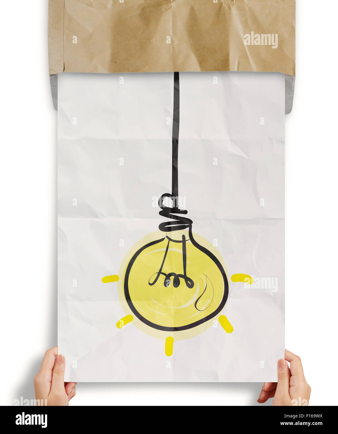 hand pulling light bulb crumpled paper out of recycle envelope as ...