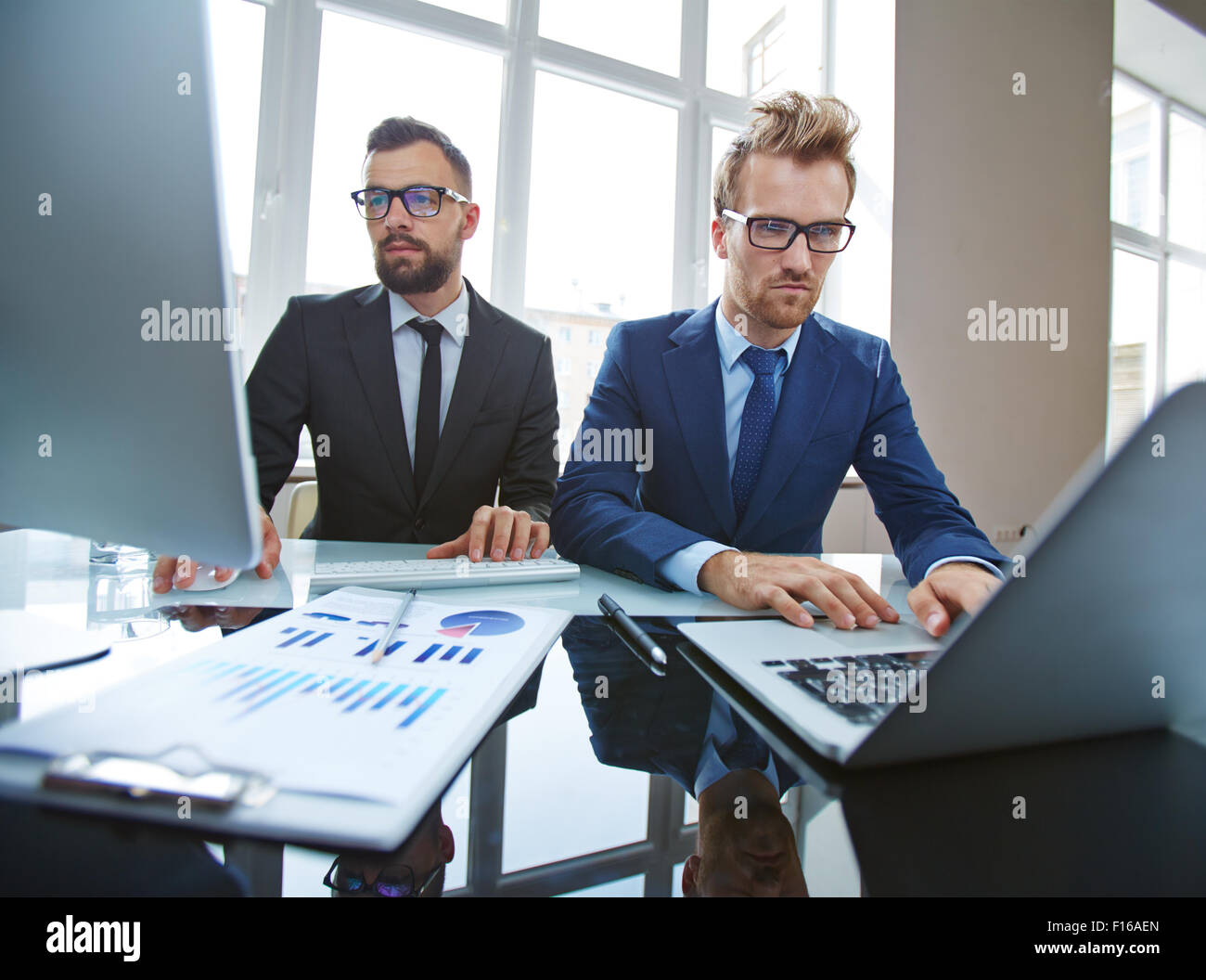 Two serious businessmen networking in office Stock Photo - Alamy