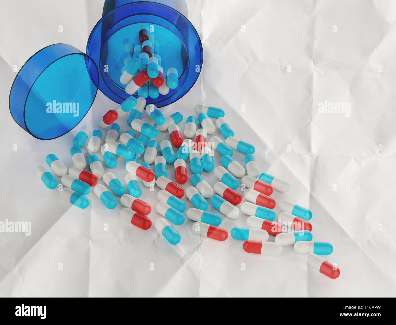 Pills spilling out of pill bottle on crumpled paper background Stock ...