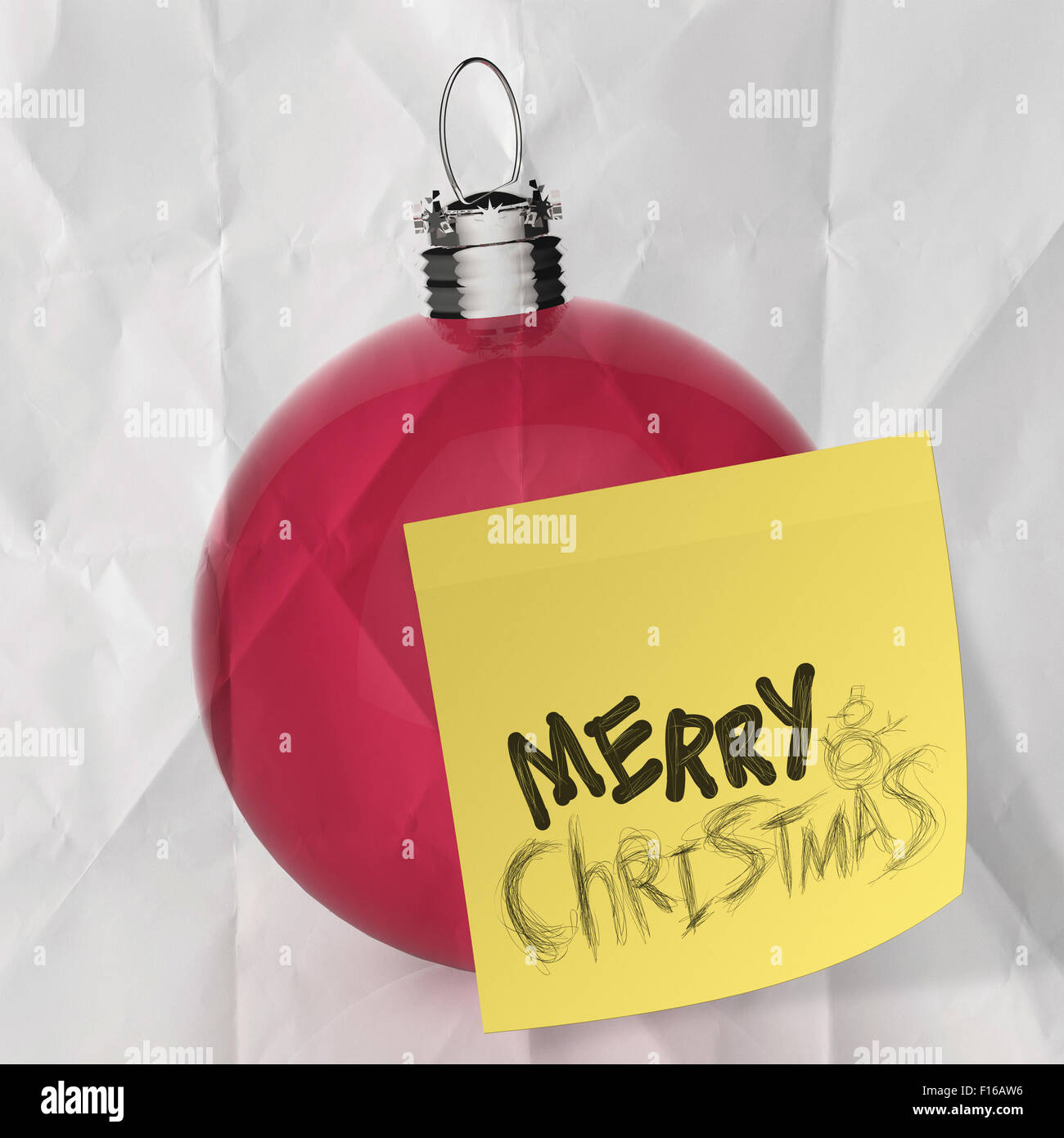 Empty Christmas ball ornament on crumpled paperand sticky note ...