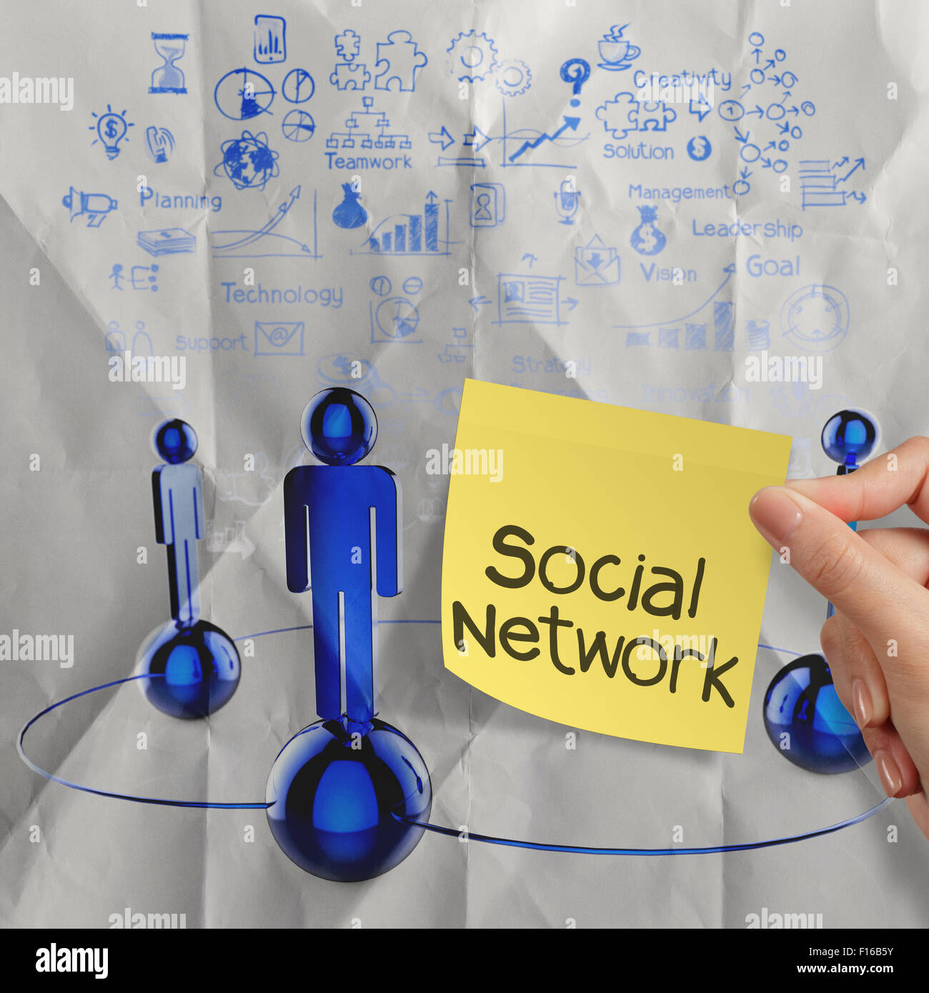 hand holding sticky note human social network on crumpled paper ...