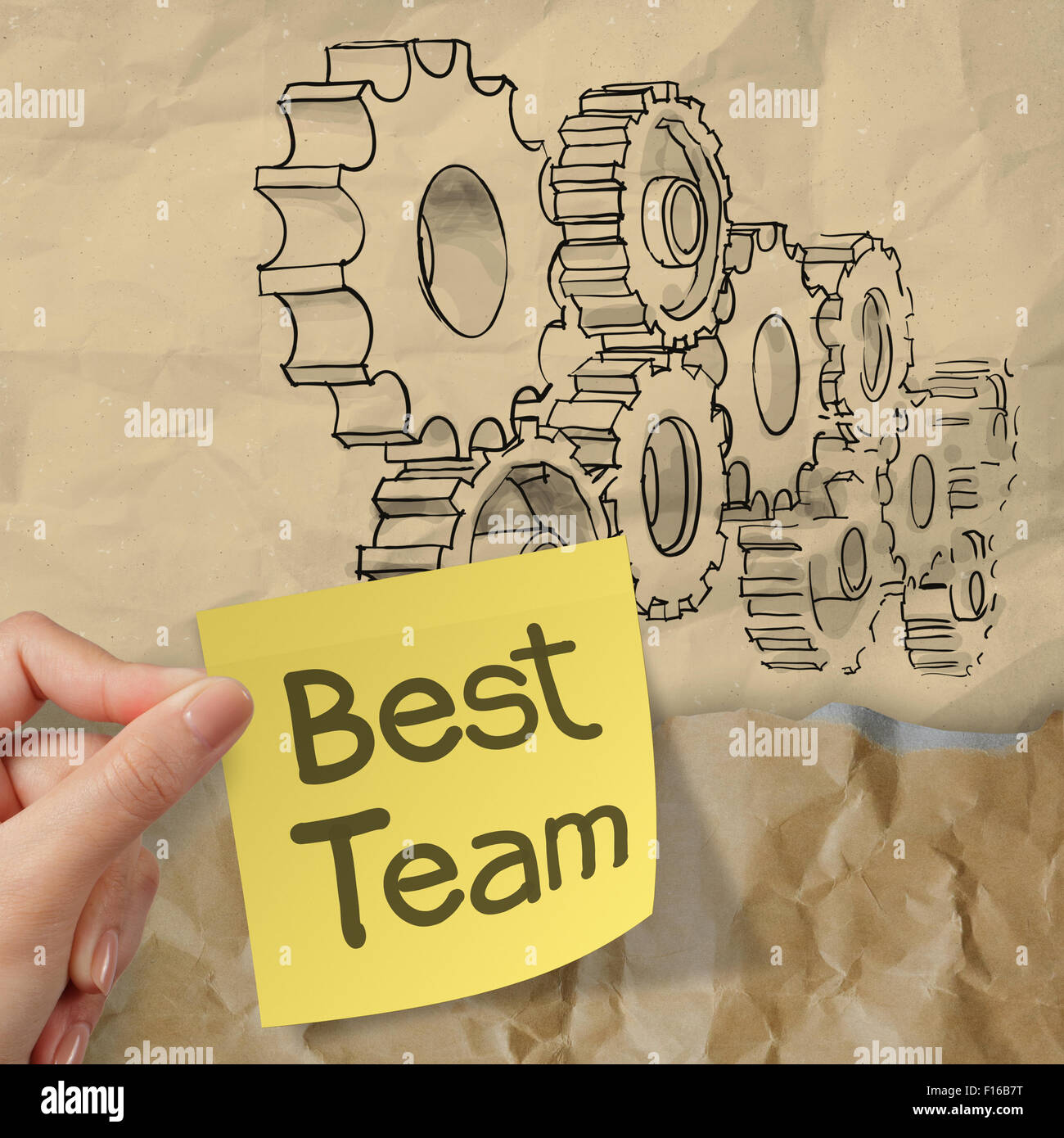hand hold sticky note with best team word with gear to success concept ...