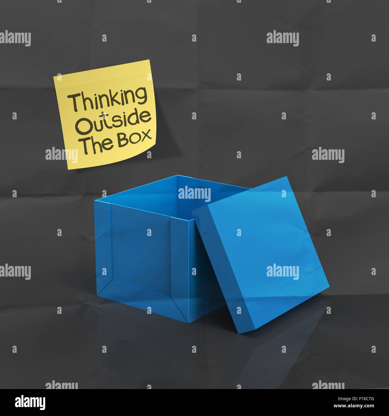 sticky note with thinking outside the box on dark crumpled paper as ...