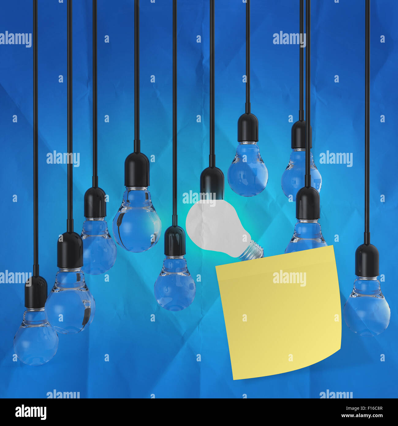 blank sticky note with another idea light bulb on crumpled paper as ...