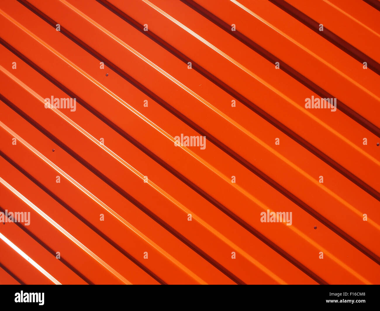 Orange metal corrugated sheet metal closeup with longitudinal stripes ...