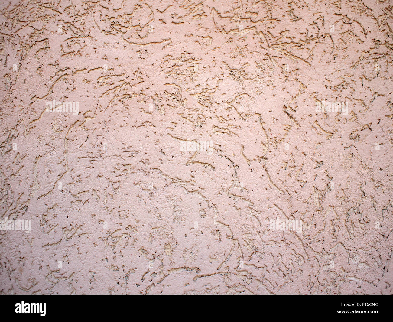 The uneven surface of the wall of gray-pink color with decorative ...
