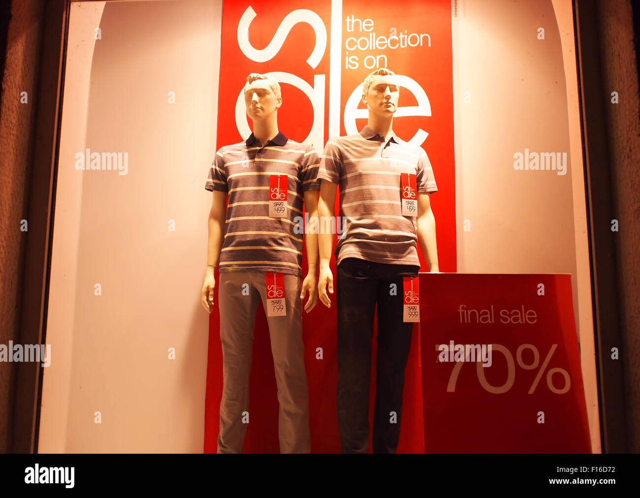 Two male mannequin in a showcase, dressed in typical pants and shirts ...