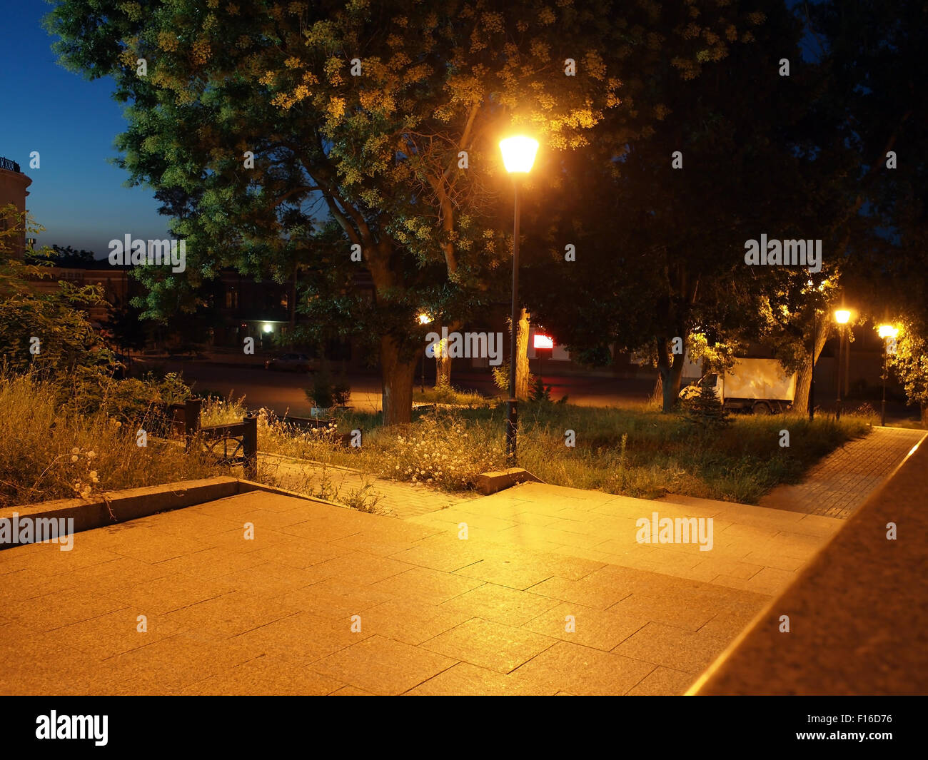 Night scene of the city. Bright street lights and staircase of granite ...