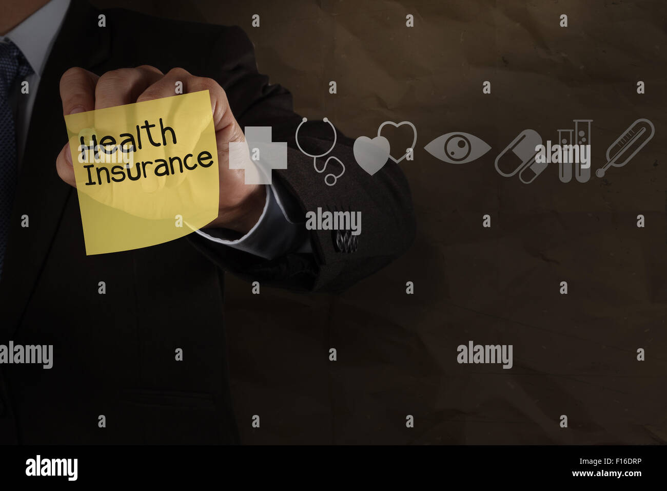 businessman hand draws health insurance with sticky note and medical ...