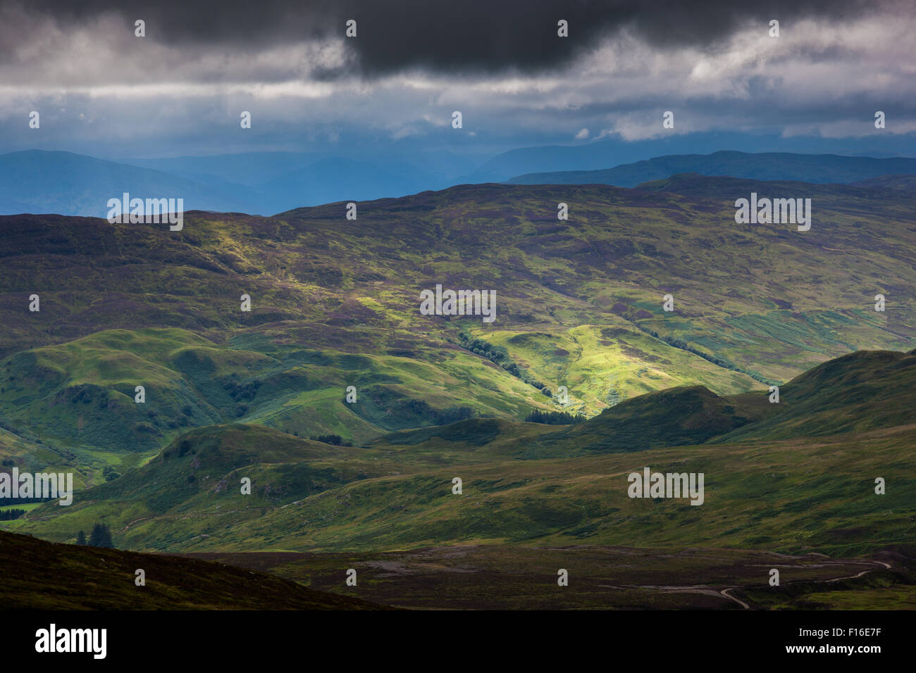 Sunlight falling on the lower flanks of Mor Bheinn, near Comrie, as ...