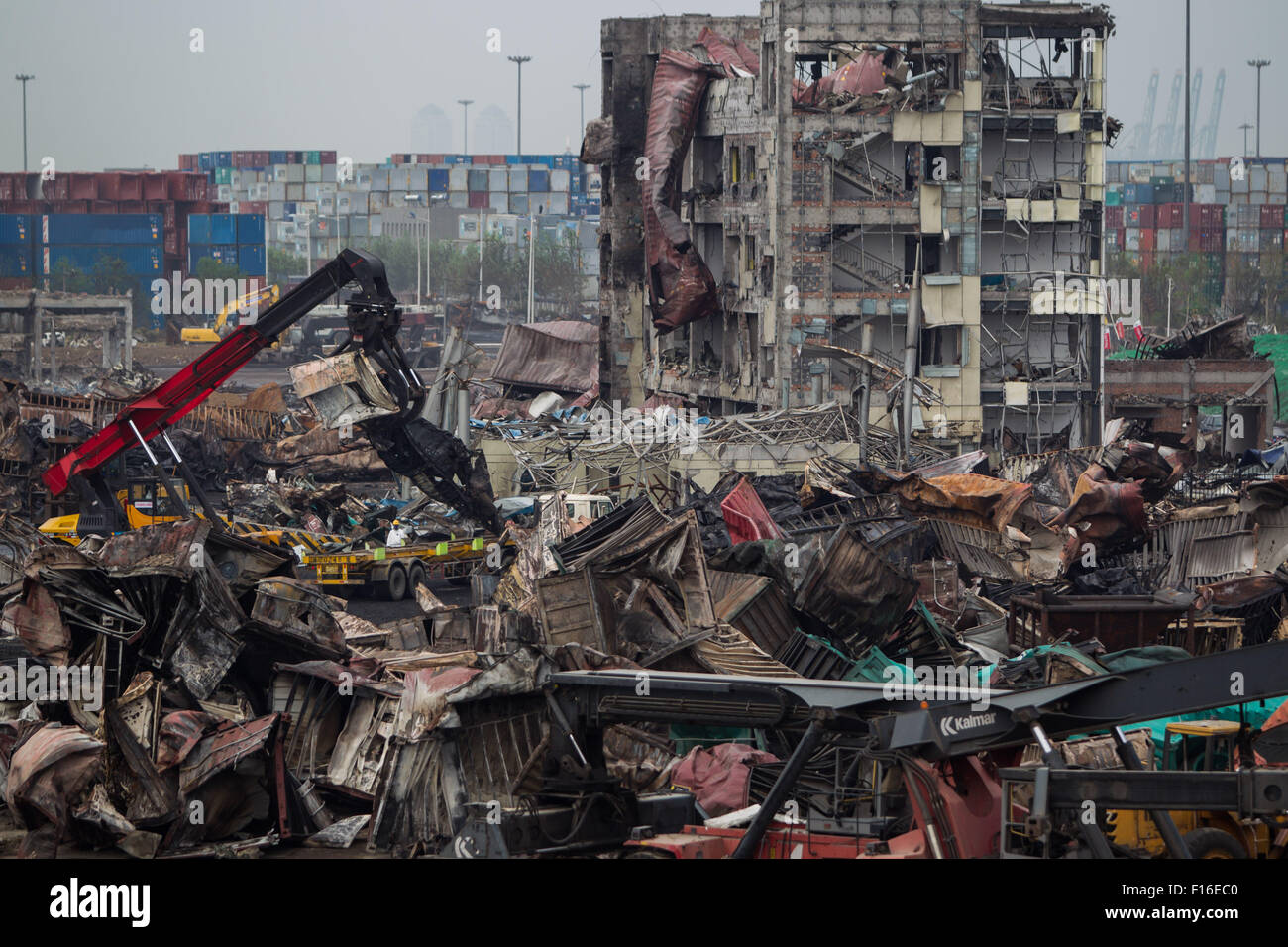 Tianjin. 28th Aug, 2015. Rescuers clean up containers at the accident ...