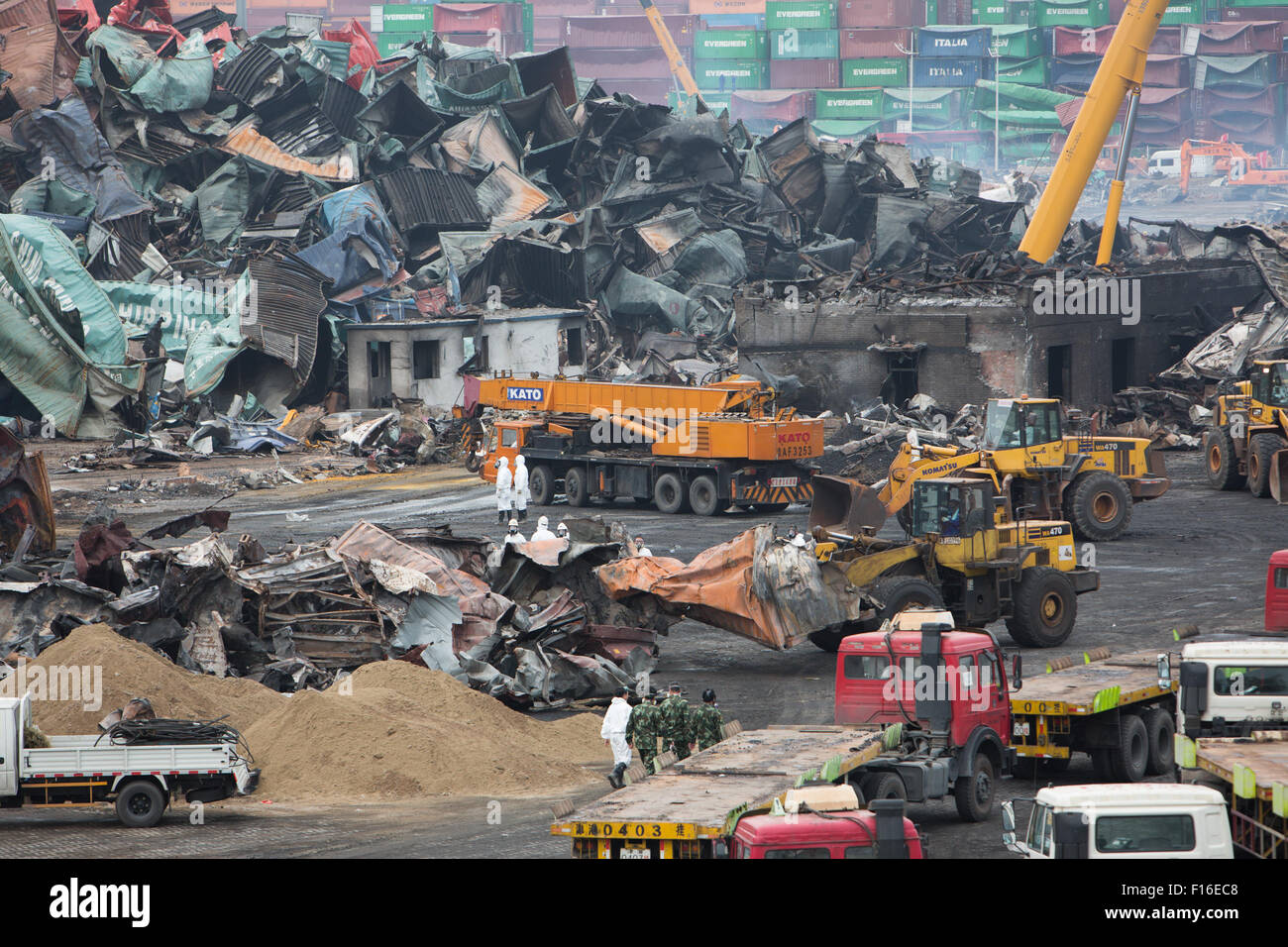 Tianjin. 28th Aug, 2015. Rescuers clean up containers at the accident ...