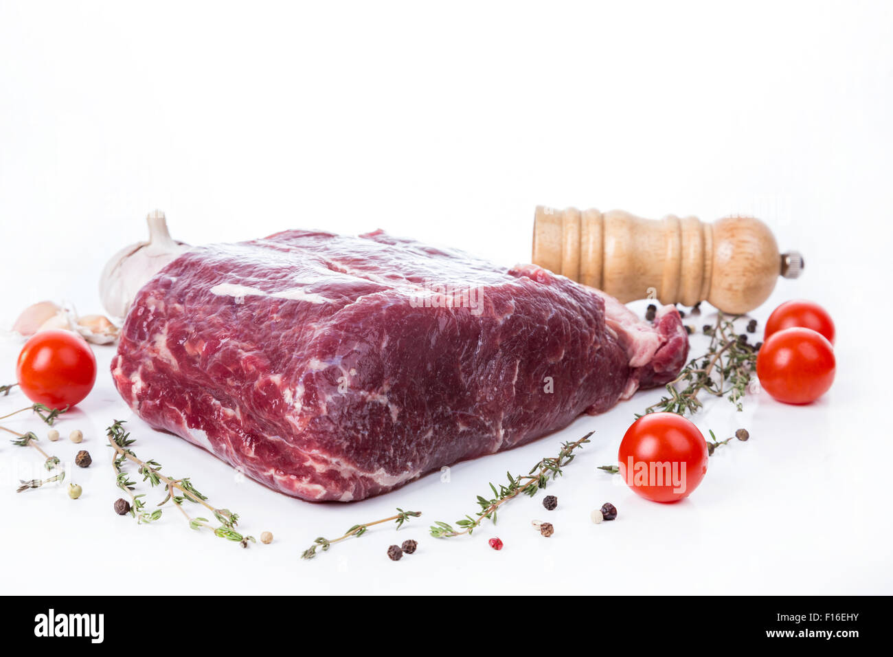 uncooked raw piece of meat fillet with serving spices on white ...