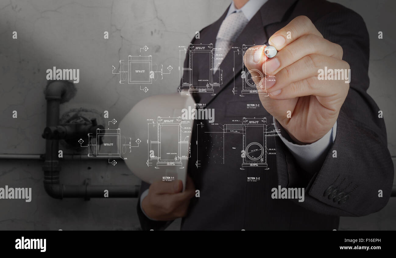 engineer drawing manhole with the piping of an industrial waste water ...