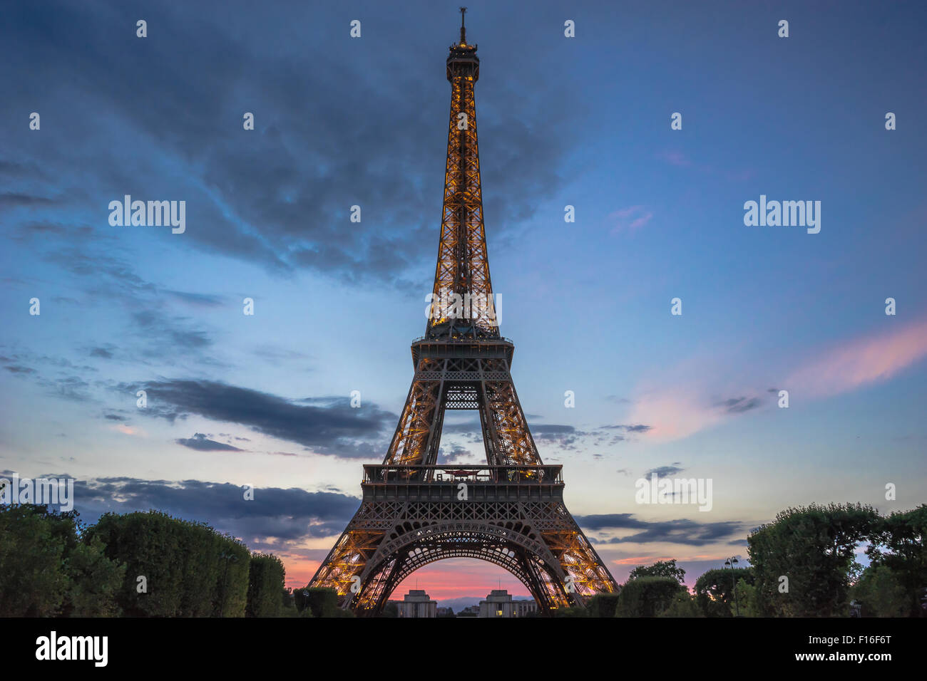 Ground straight view of the Eiffel Tower at sunset Stock Photo - Alamy