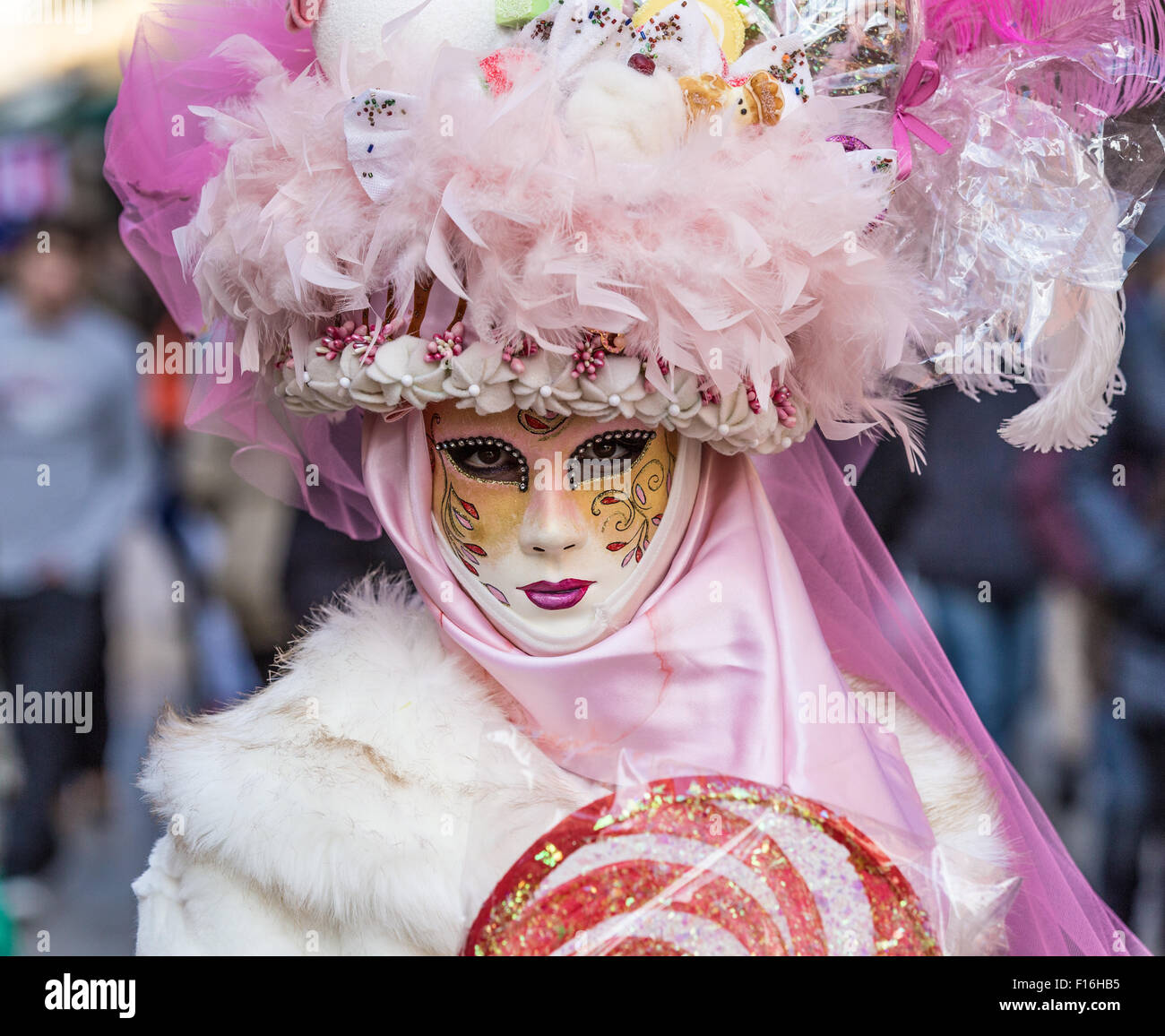 A Carnival model with pink feathers and giant lollipop at the Venice ...