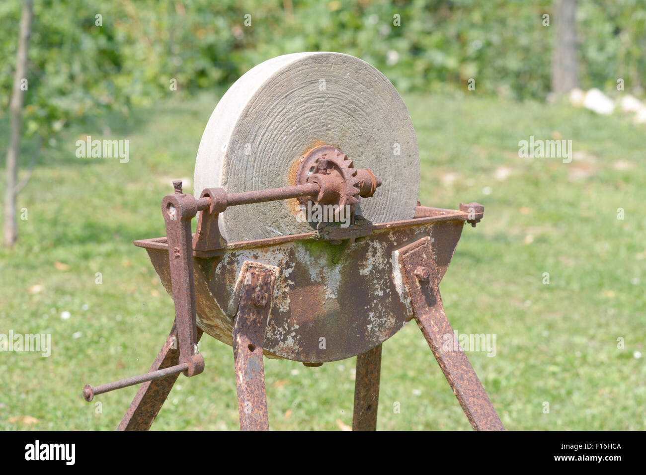 Circular sharpening stone with handle used to sharpen agricultural ...