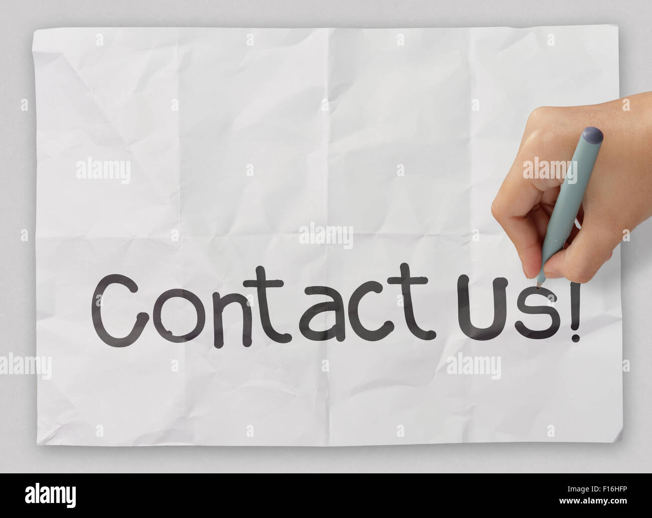 Hand writing Contact us as concept Stock Photo - Alamy