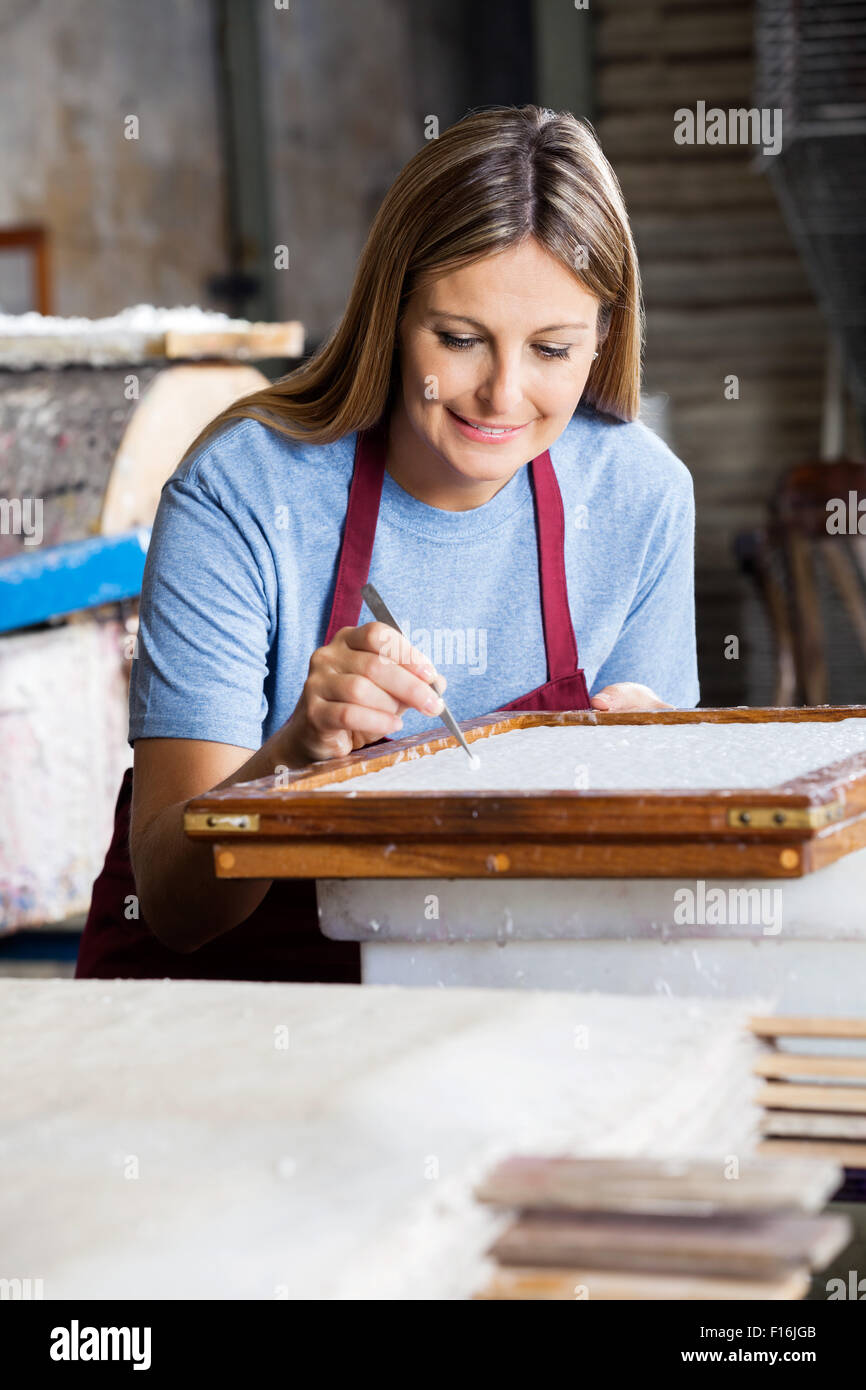 Worker Cleaning Paper On Mold With Tweezers In Factory Stock Photo - Alamy