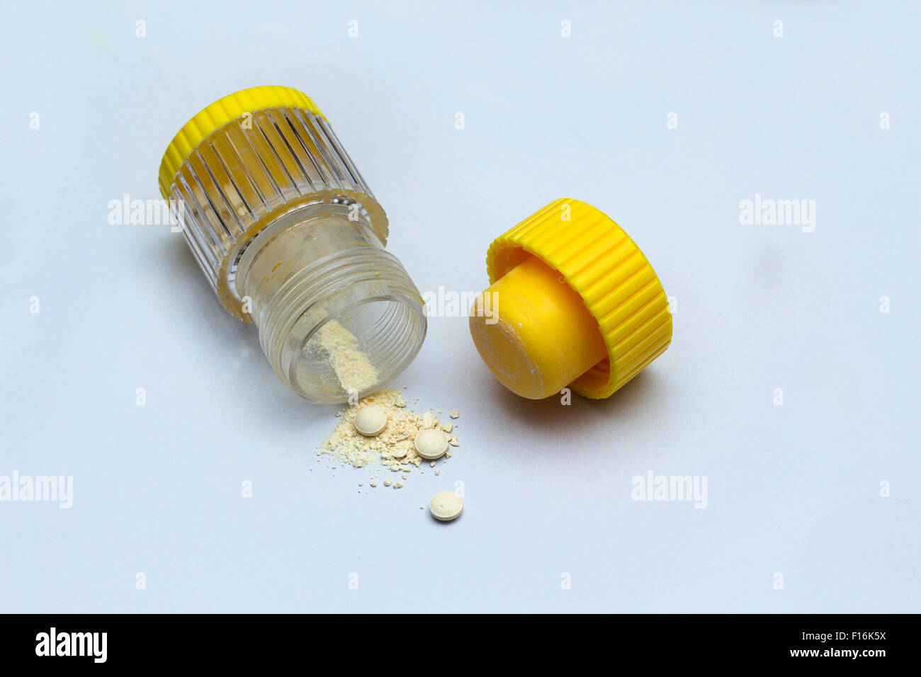 A spilled pill crusher on its side with its lid unscrewed Stock Photo ...