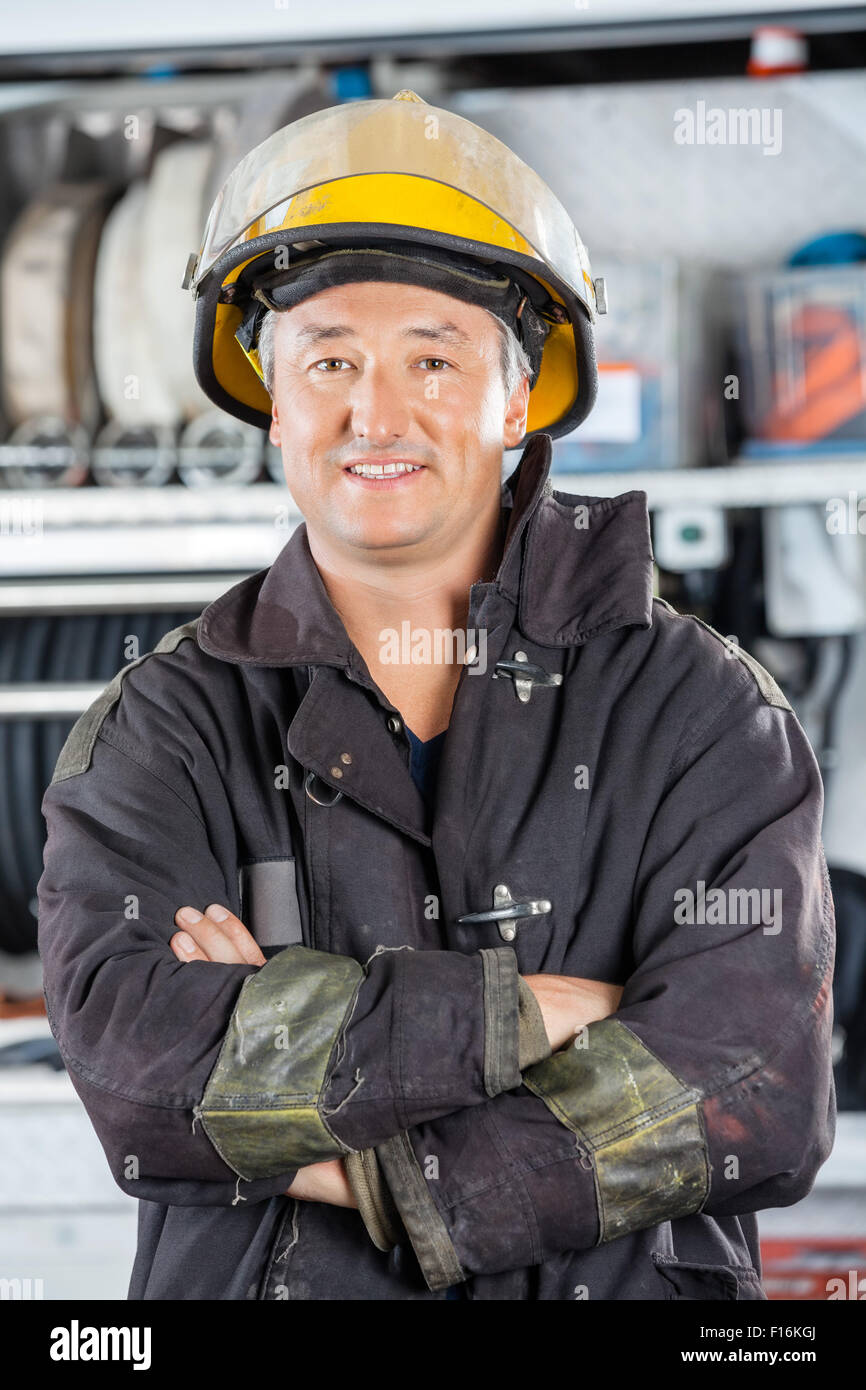 Happy Fireman Standing At Fire Station Stock Photo - Alamy