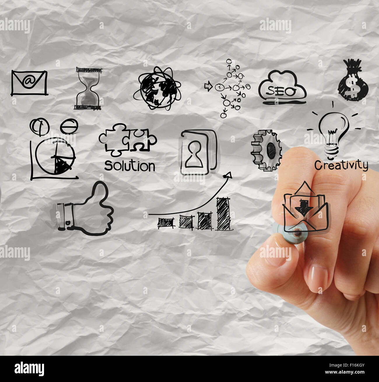 hand drawing creative business strategy on crumpled paper background as ...