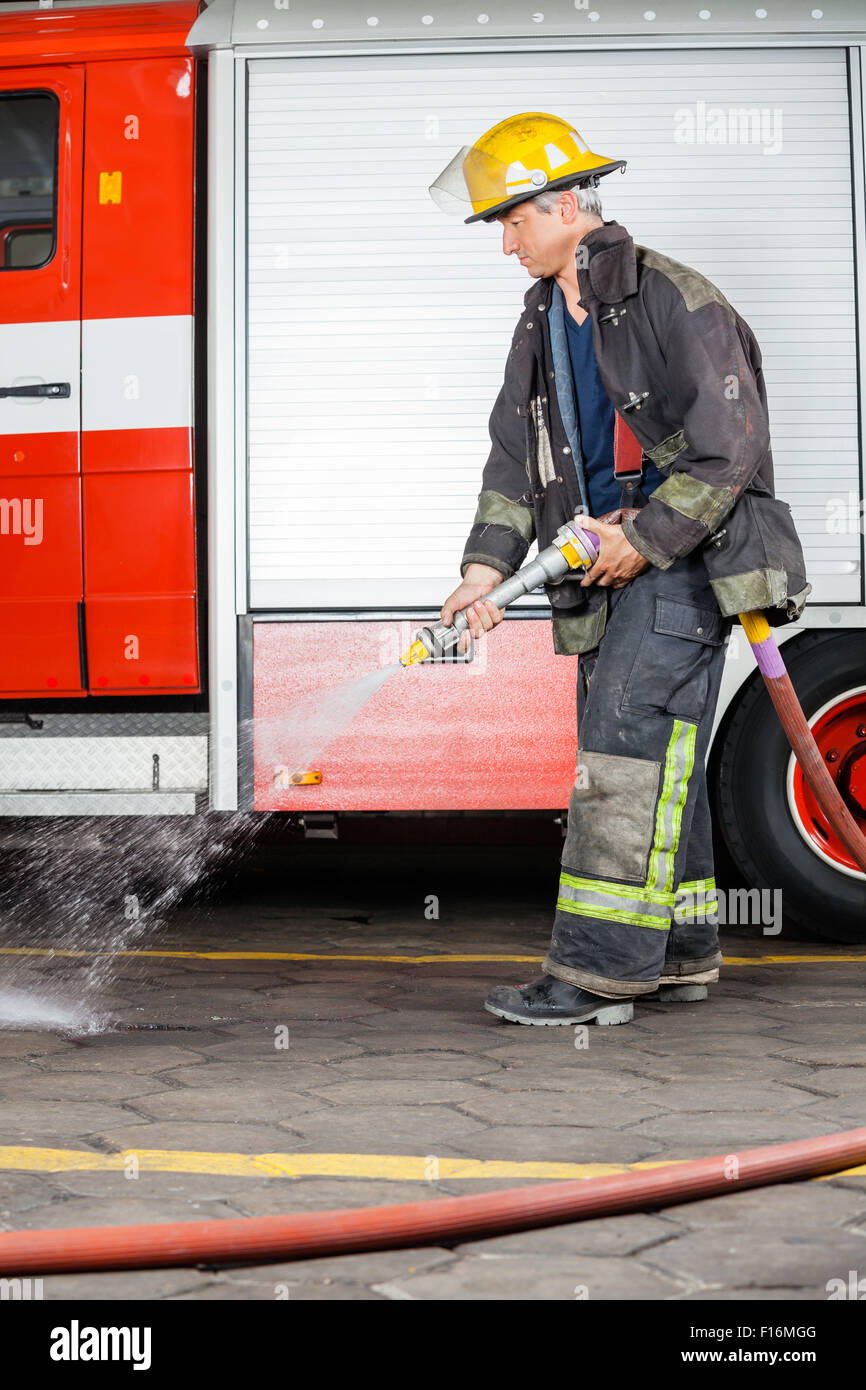 Man spraying water on an engine hi-res stock photography and images - Alamy