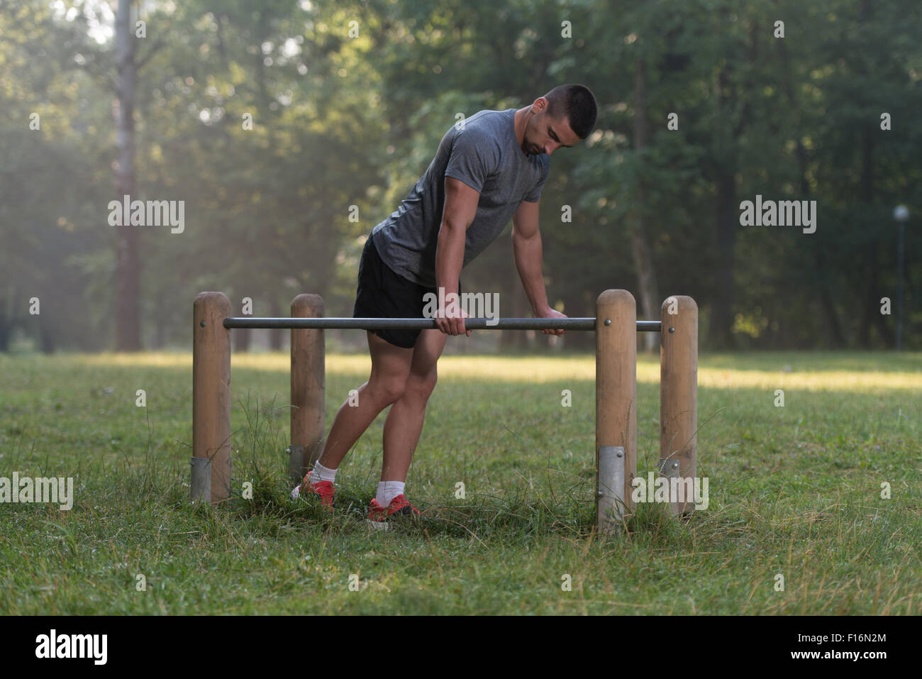 Handsome Muscular Young Man Workout In The Park Stock Photo - Alamy