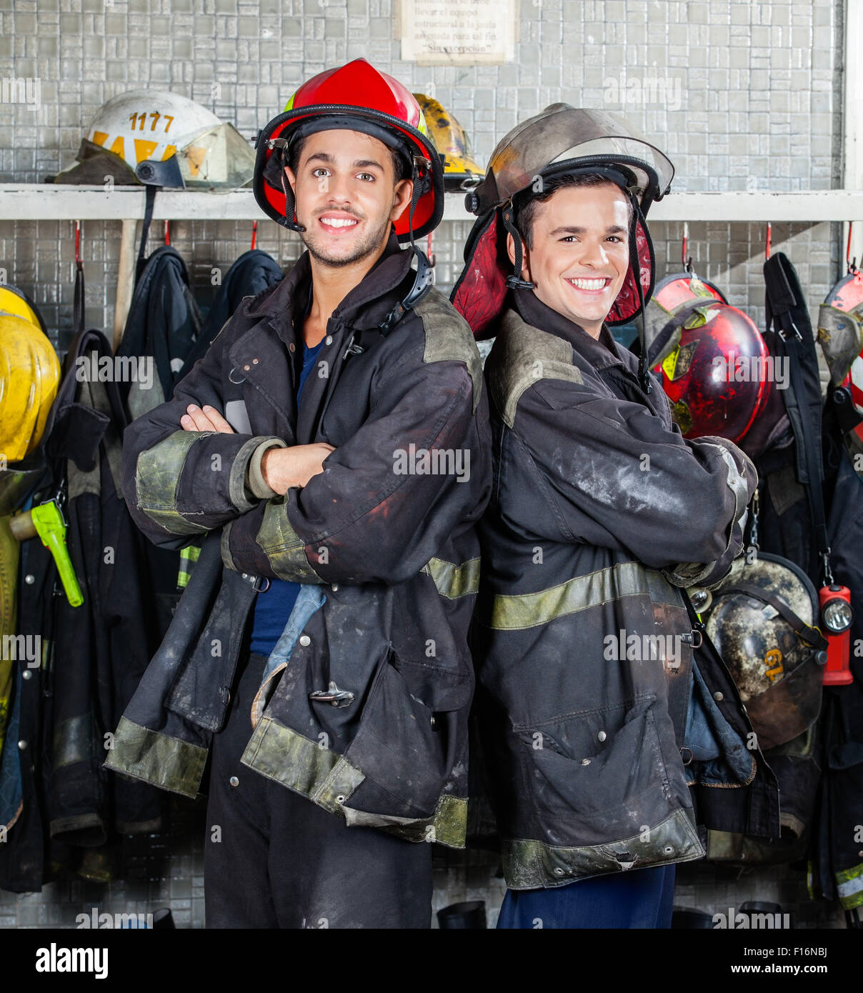 Happy Firefighters Standing Arms Crossed Stock Photo - Alamy