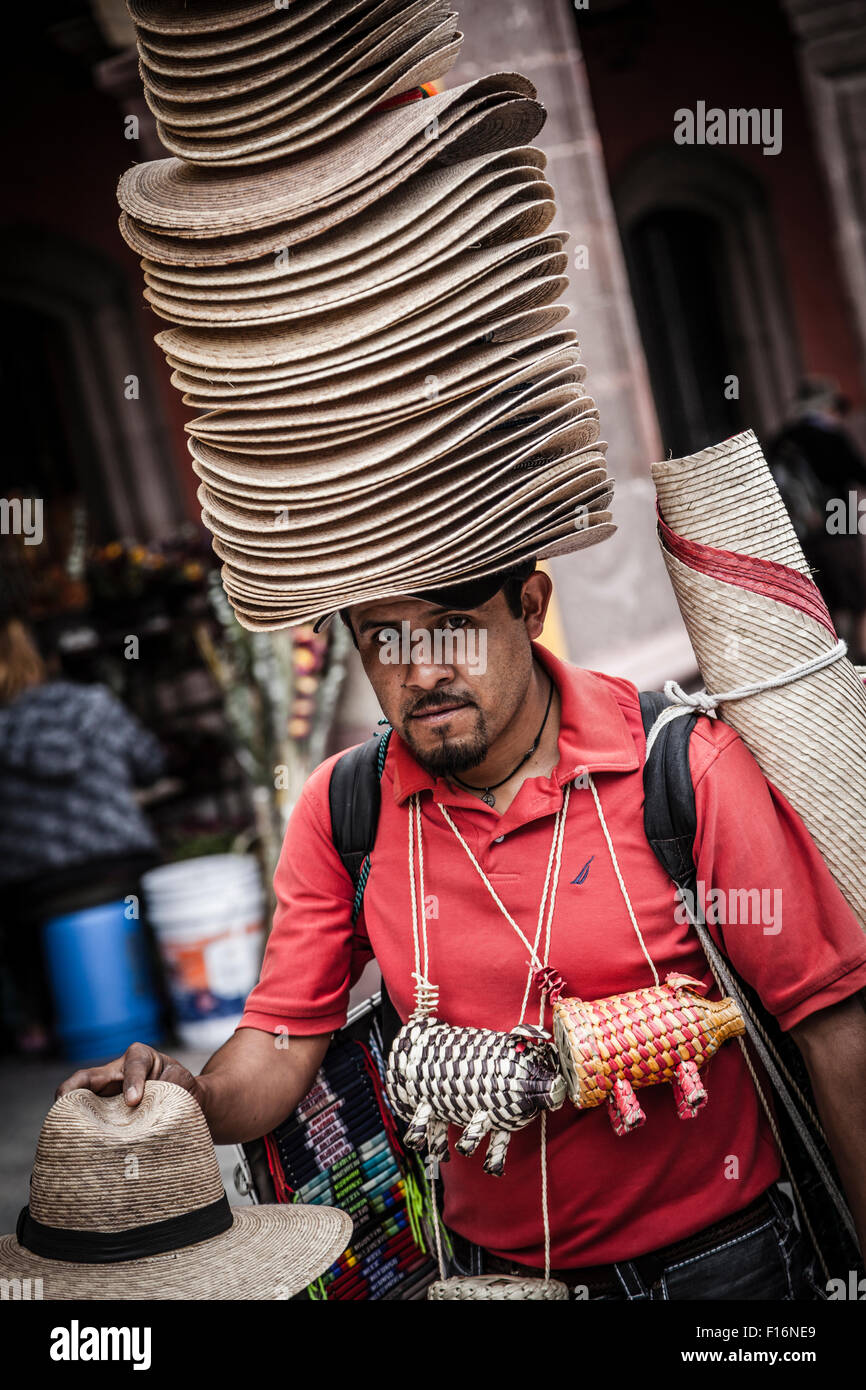 Guy selling hats at San Miguel de Allende Plaza, Mexico Stock Photo - Alamy