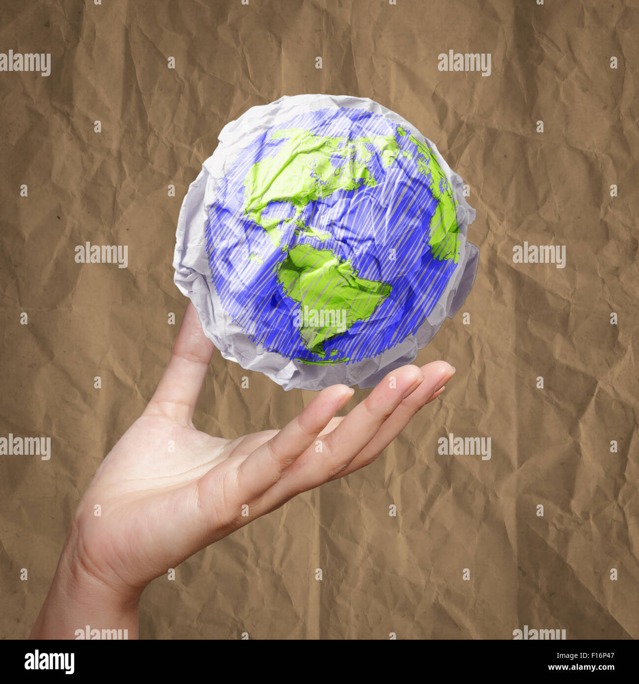 hand showing crumpled world paper symbol on crumpled recycle paper as ...
