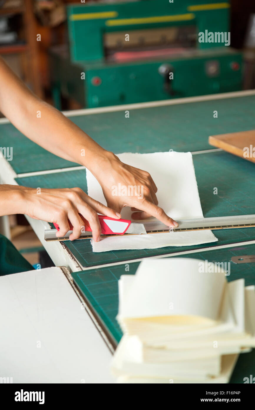 Woman's Hands Cutting Paper Using Blade On Table Stock Photo - Alamy