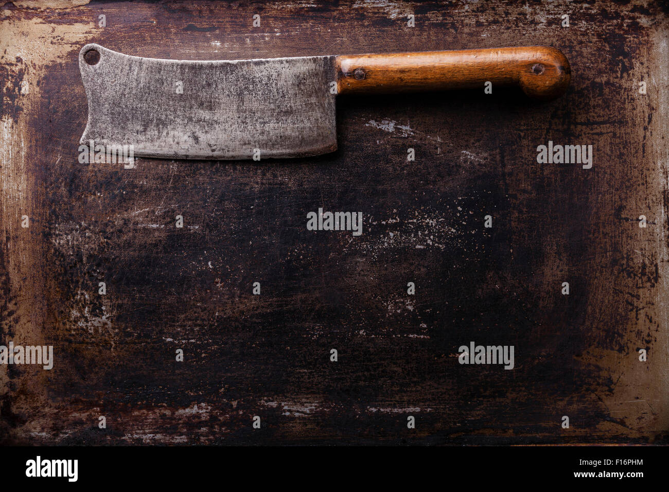 Vintage Meat cleaver on old scratched black dark background texture ...