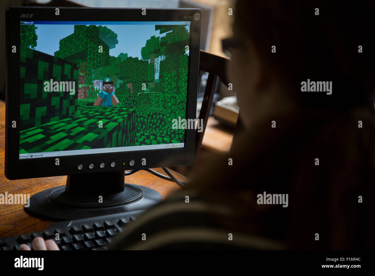 Teenage girl plays the video game Minecraft on a home computer Stock ...