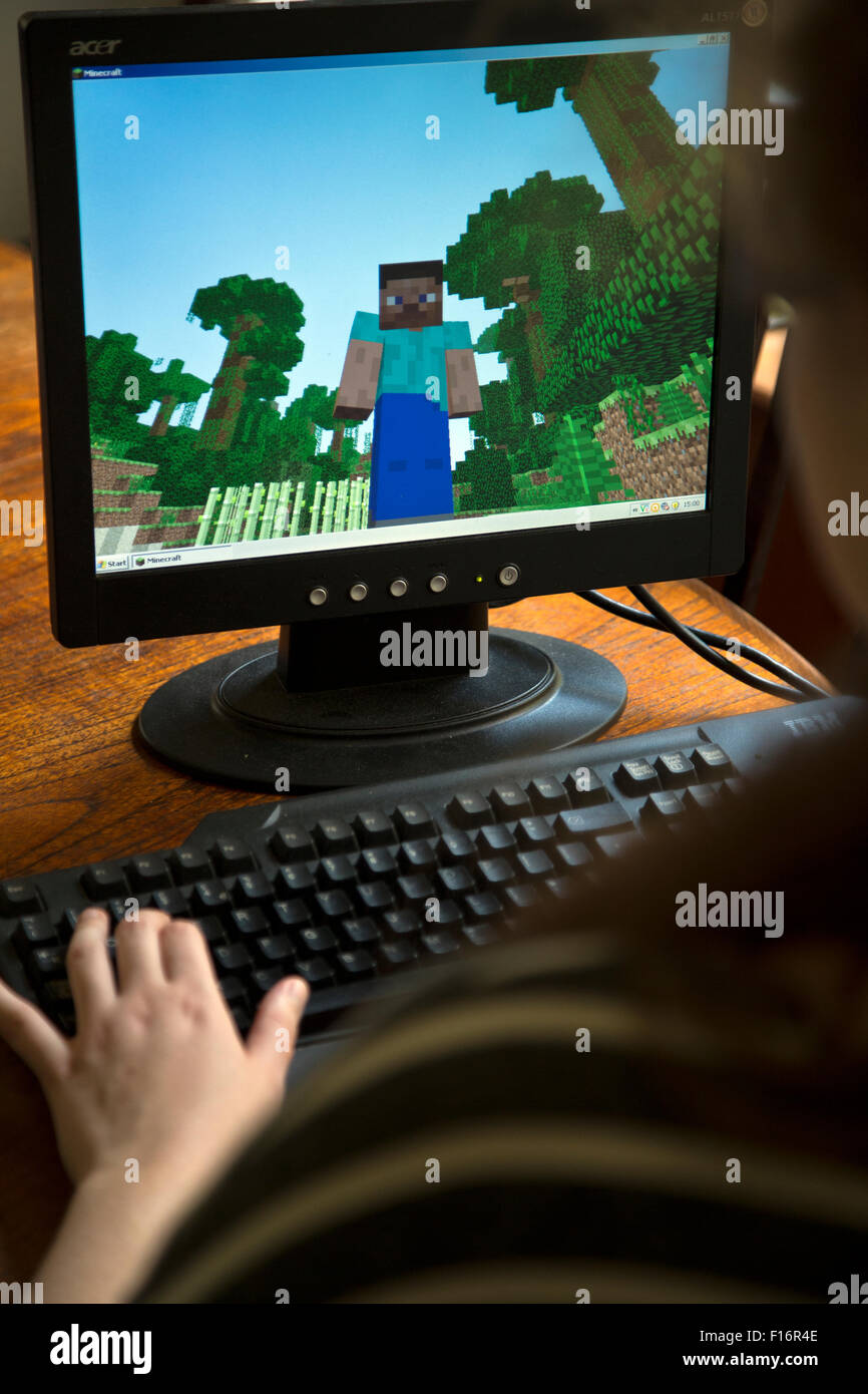 Teenage girl plays the video game Minecraft on a home computer Stock ...