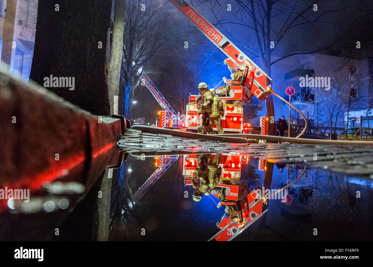 Berlin, Germany, emergency vehicle of the fire reflected in a puddle ...