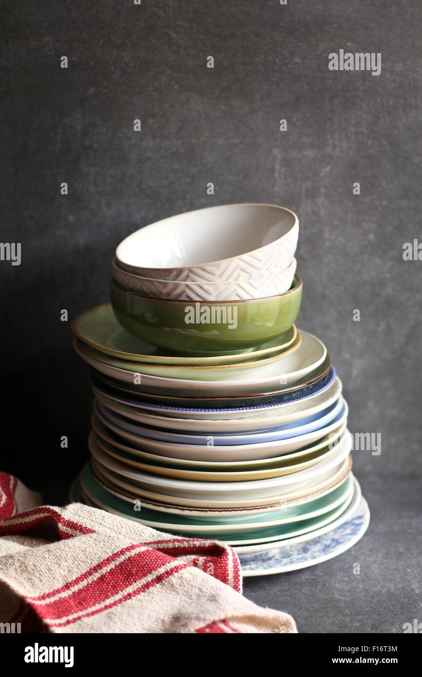 Stack of colorful plates on dark background Stock Photo - Alamy