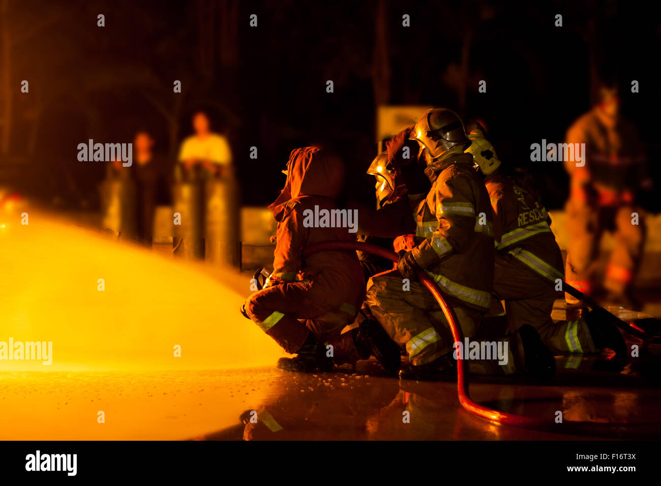 Firefighters attack a propane fire during a training exercise Stock ...