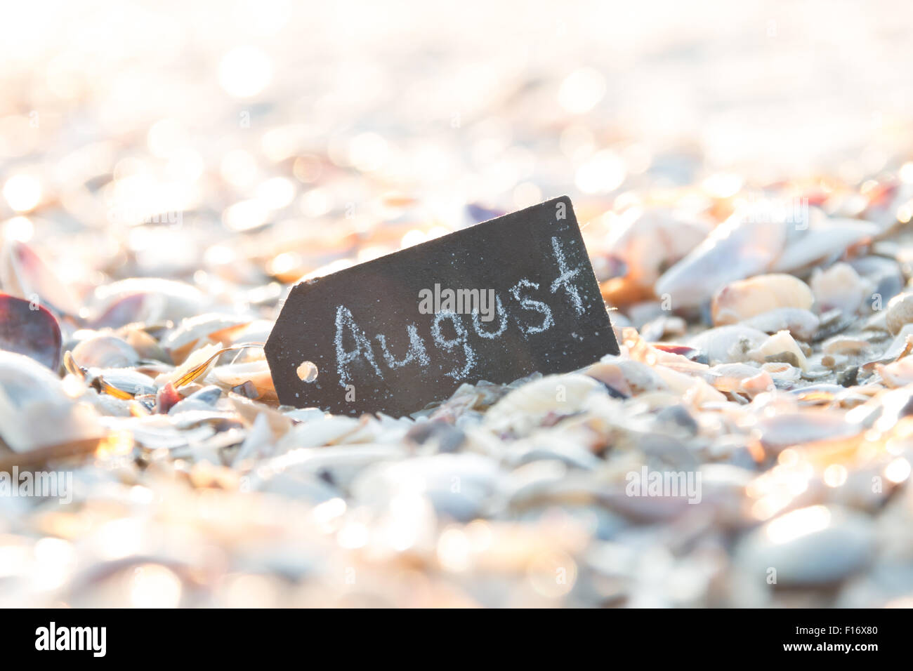 August Travel concept. Sign with the word august on the beach Stock ...